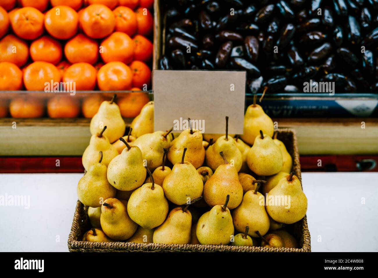 A box of pears on the market. Shop window with pears, tangerines and ...