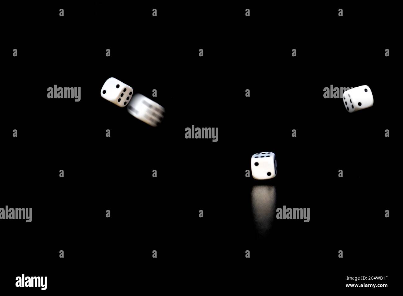 Dice being rolled Stock Photo - Alamy