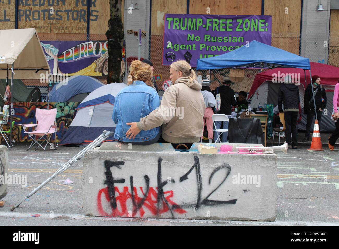 Seattle, Washington, USA. 27th June, 2020. A couple hugs at the Capitol ...