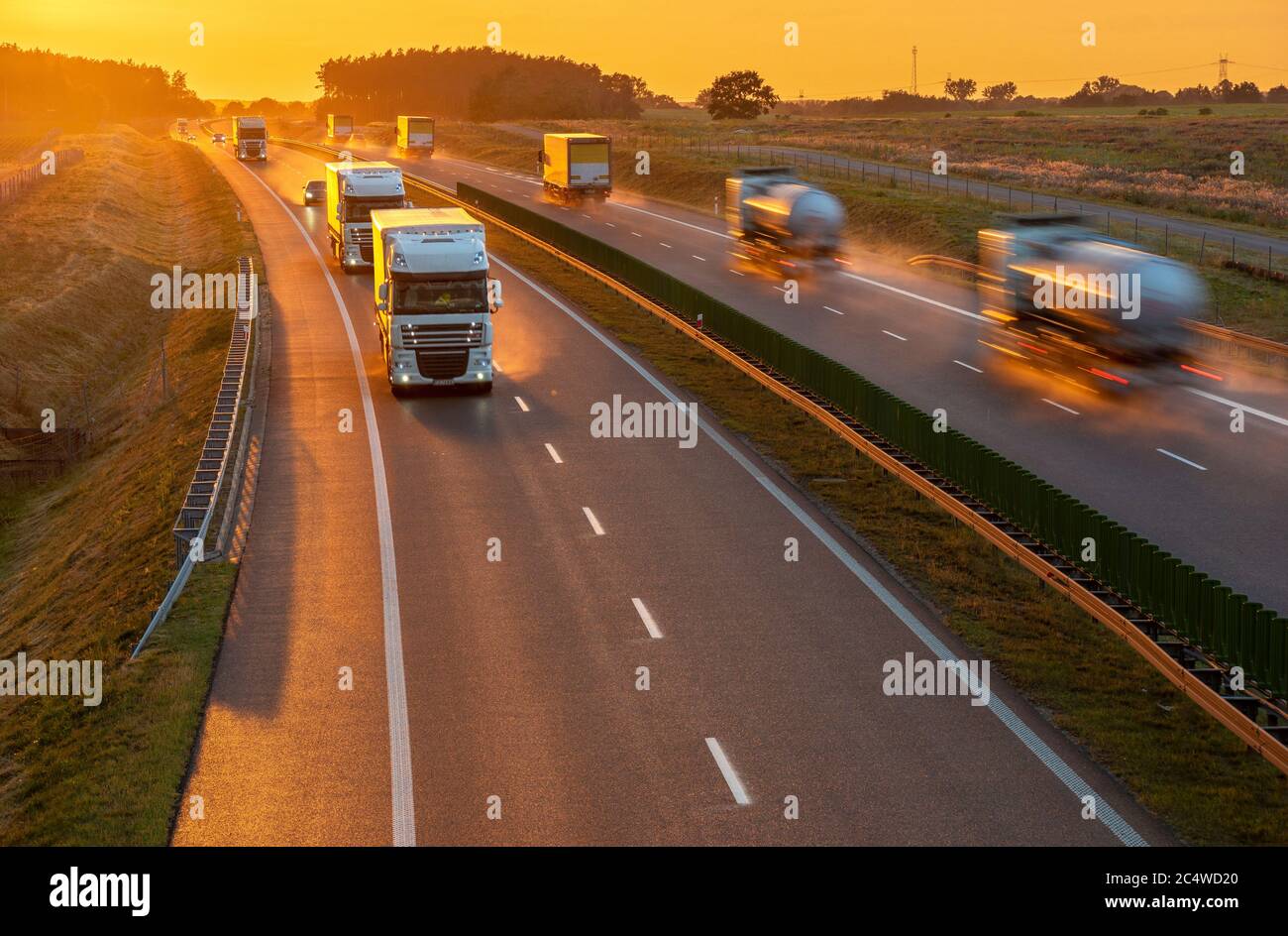 Heavy traffic on the highway during sunset after heavy rain Stock Photo ...