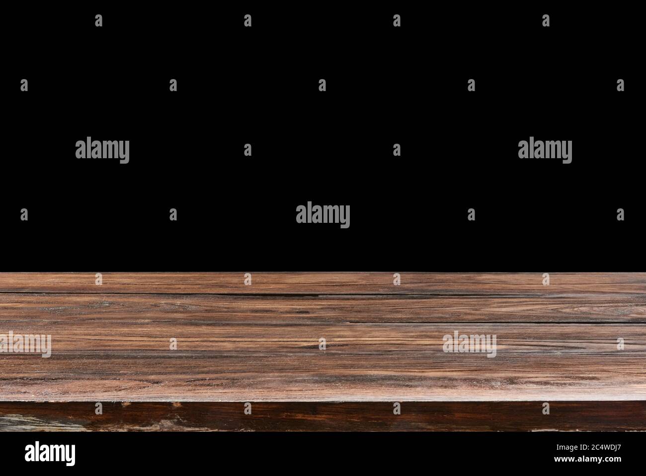 Oaken table from wooden planks on a black background for display or ...