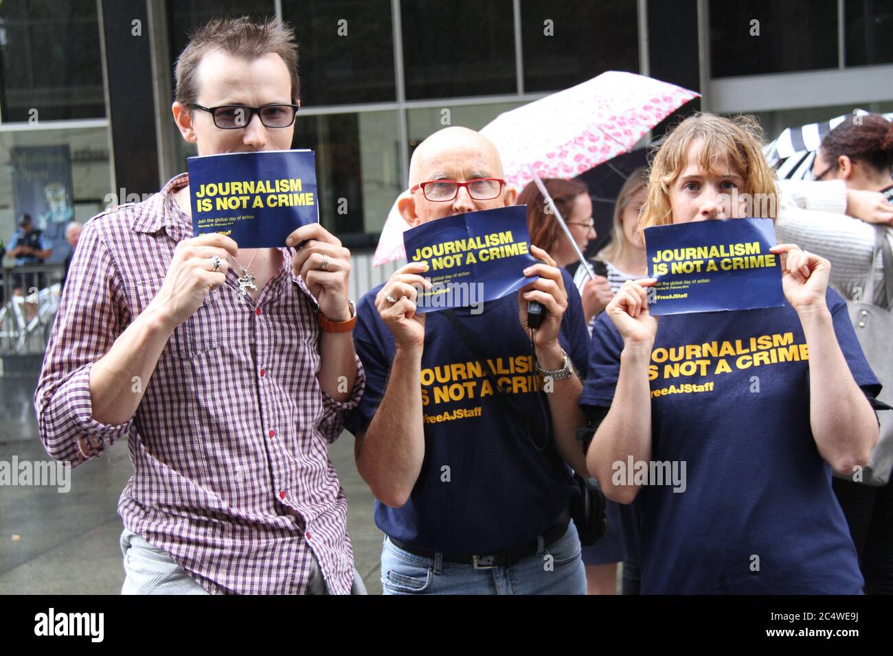 Protesters hold signs saying ‘Journalism is not a crime’ at the rally ...