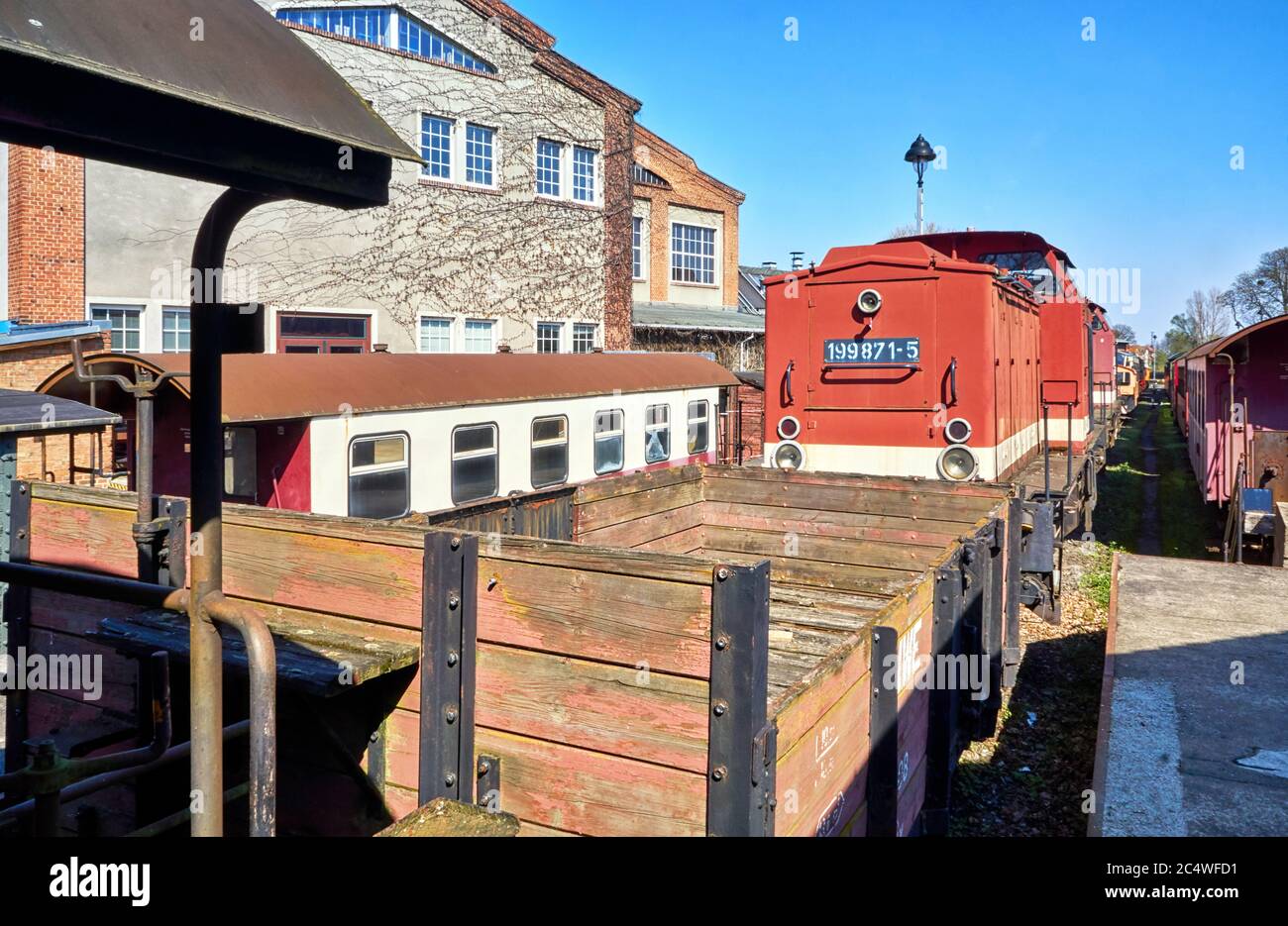 Old freight train with wooden wagons at a freight yard. Diesel ...