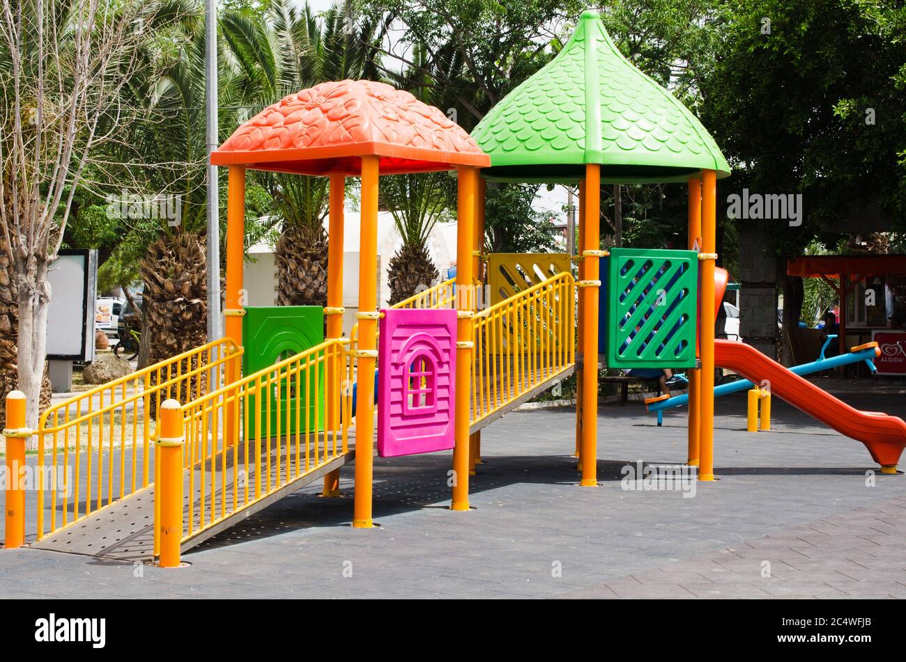 Colorful children playground activities in public park surrounded by ...