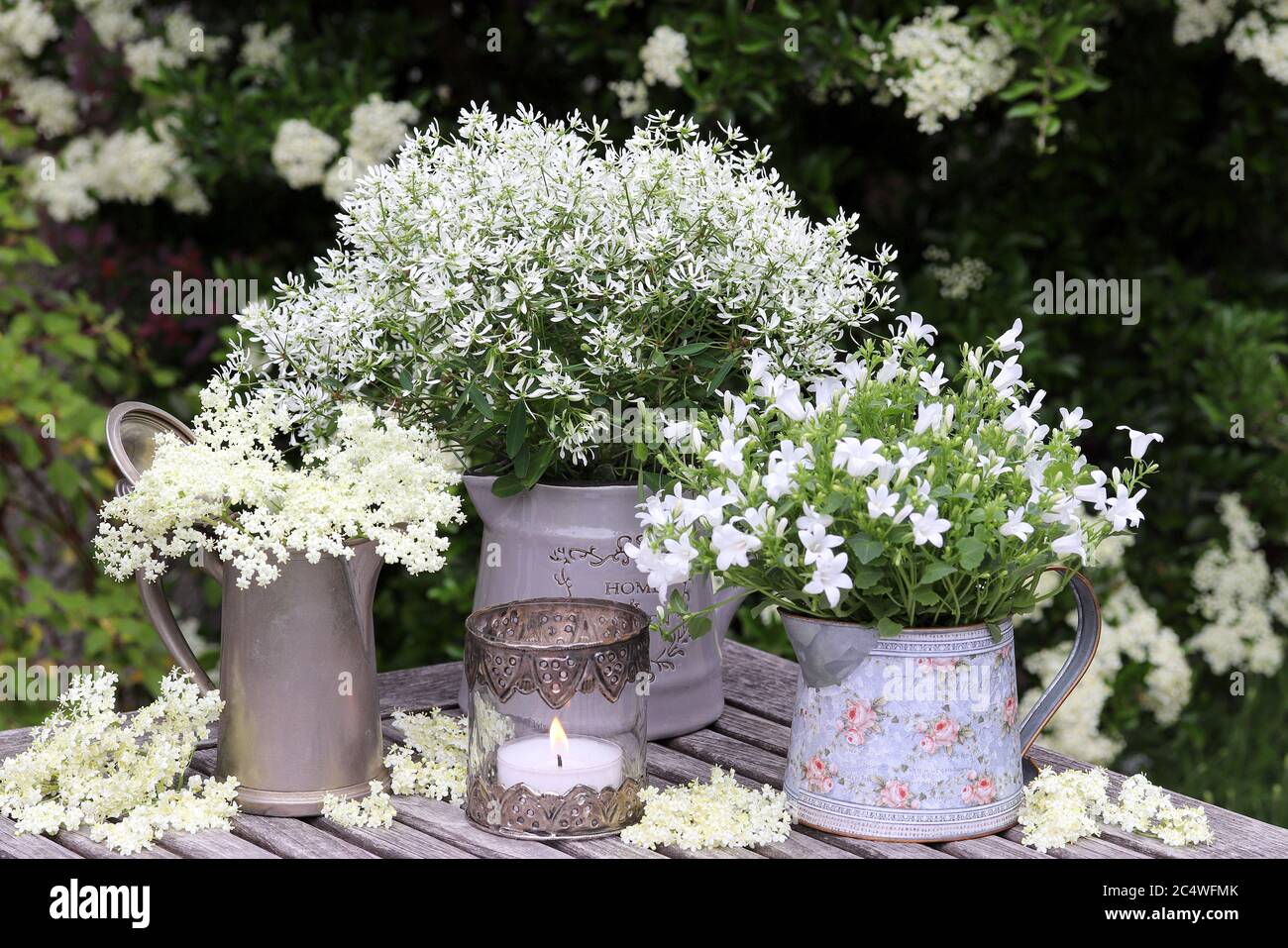 garden decoration with white flowers in vintage vases Stock Photo - Alamy