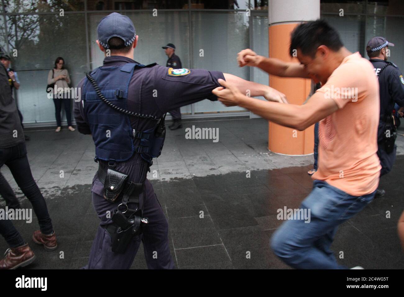 A policeman throws a refugee protester back to stop him reaching the ...