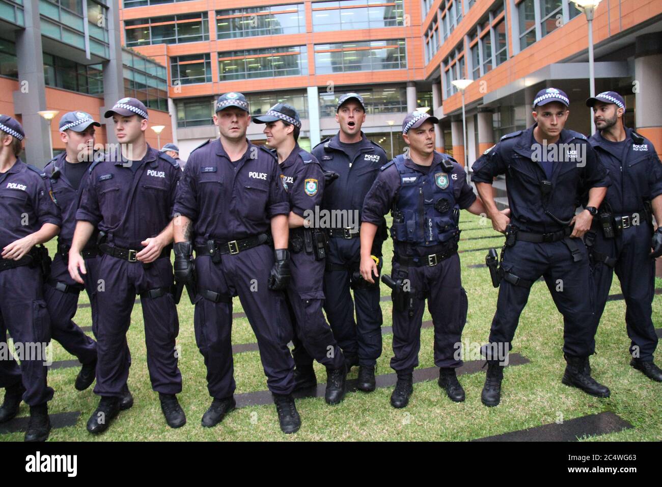A line of police tries to keep refugee protesters away from the ...