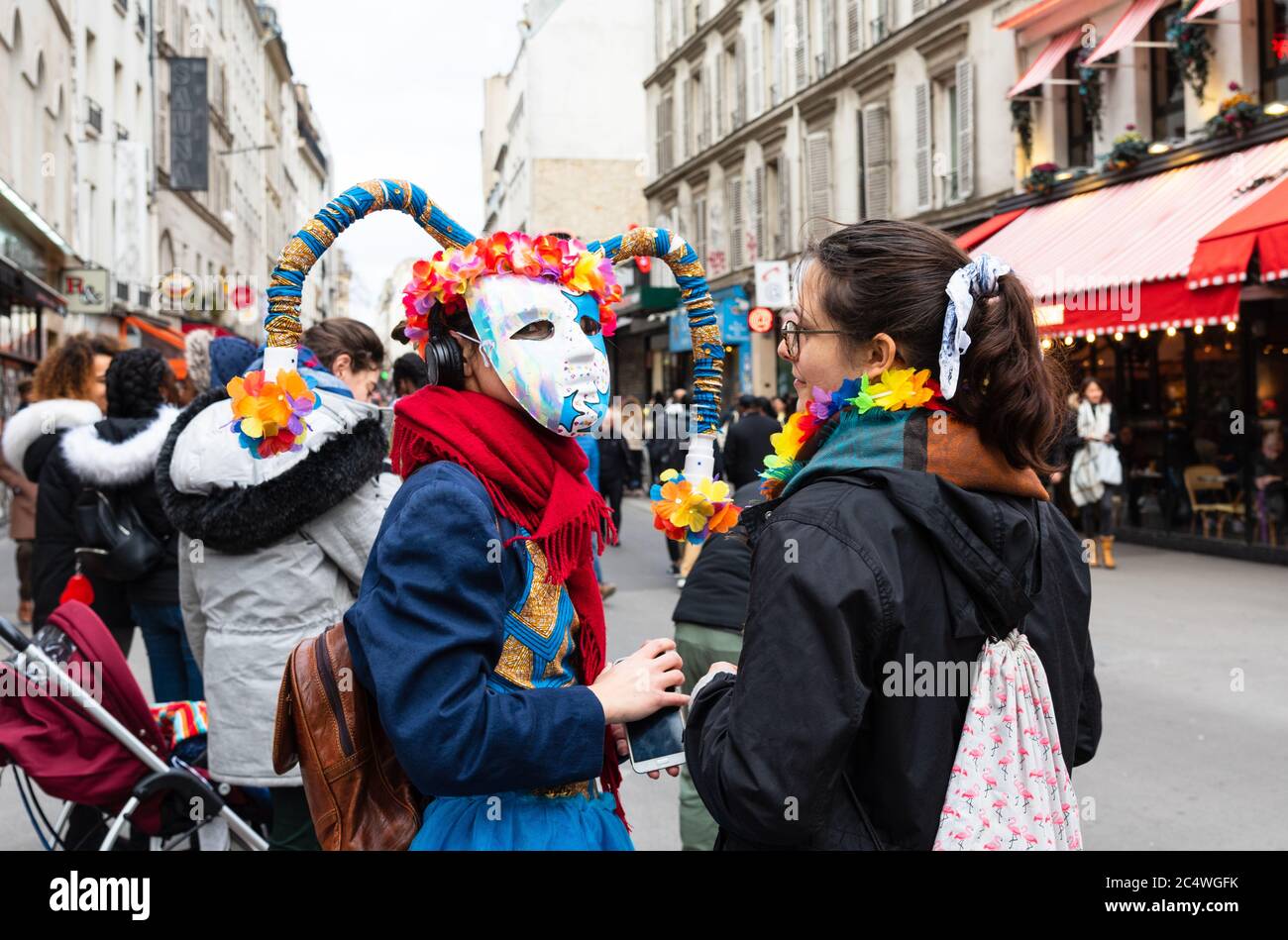 PARIS, FRANCE - FEBRUARY 23, 2020: People in masks and costumes at ...