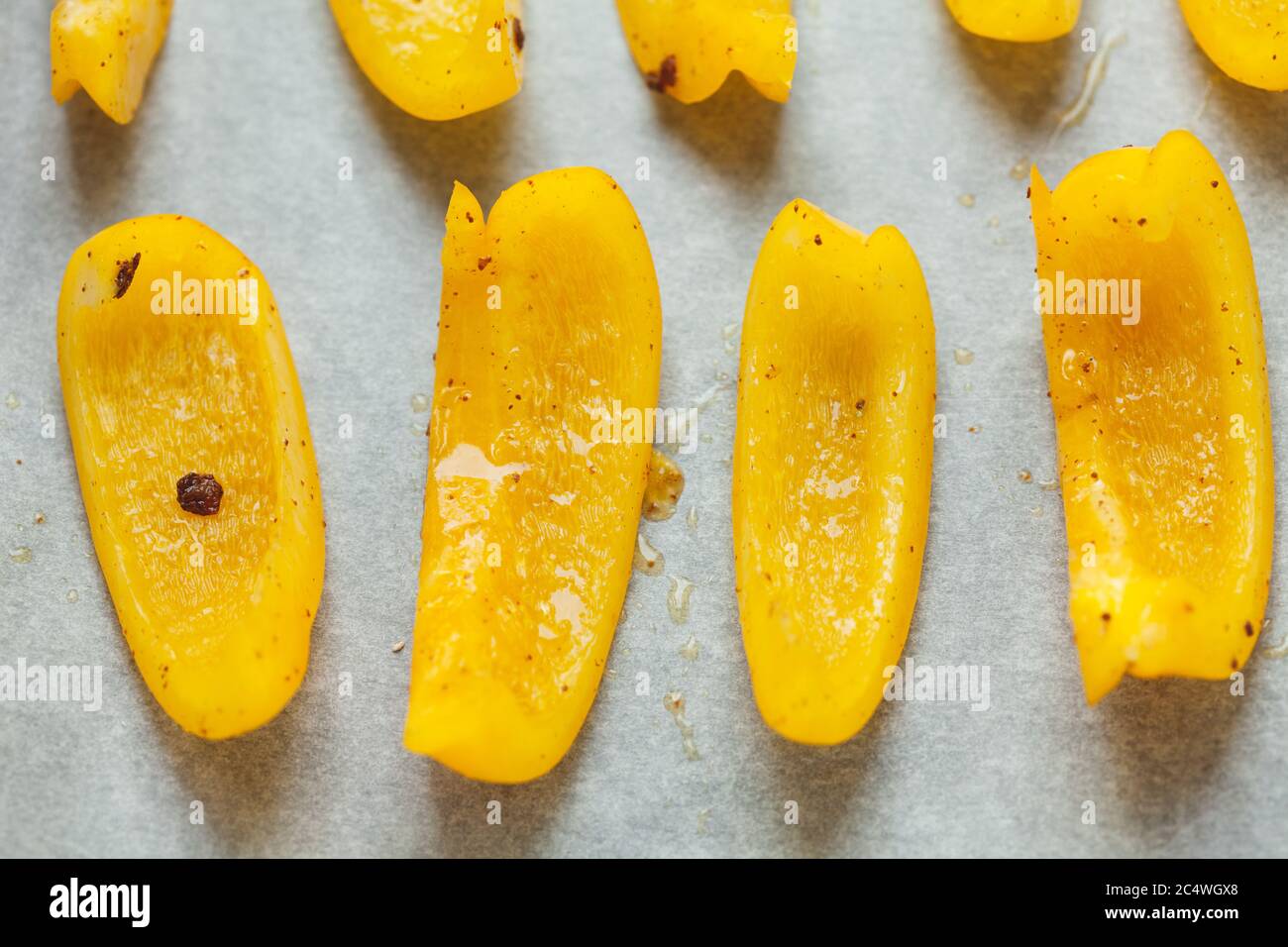 Bright slices of bell pepper prepared for baking in the oven. Soft ...