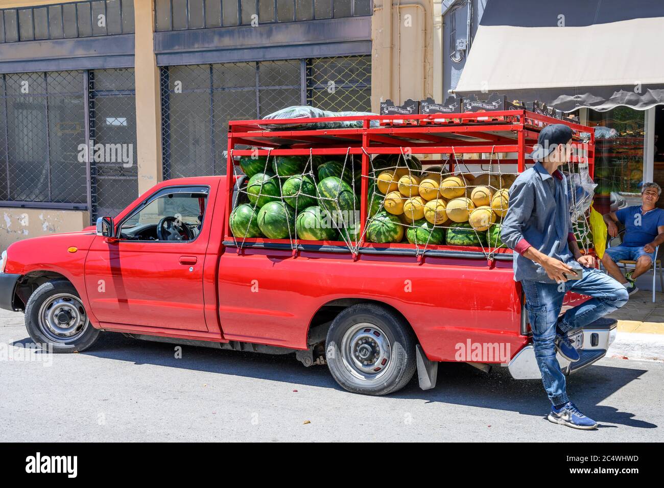 Selling melons from a pickup truck at the Sunday market in the small ...
