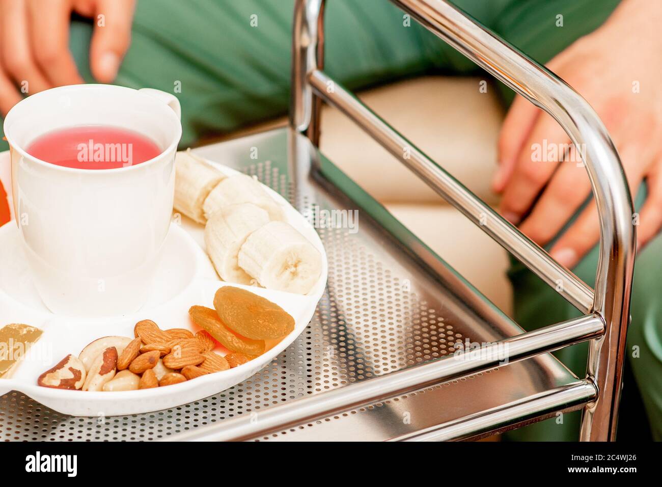Tea drinking with dried fruits between two male doctors and a woman in ...