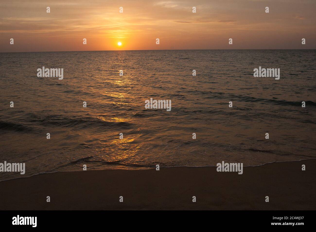 The evening sun sets in the Andaman Sea and creates a sunny path ...