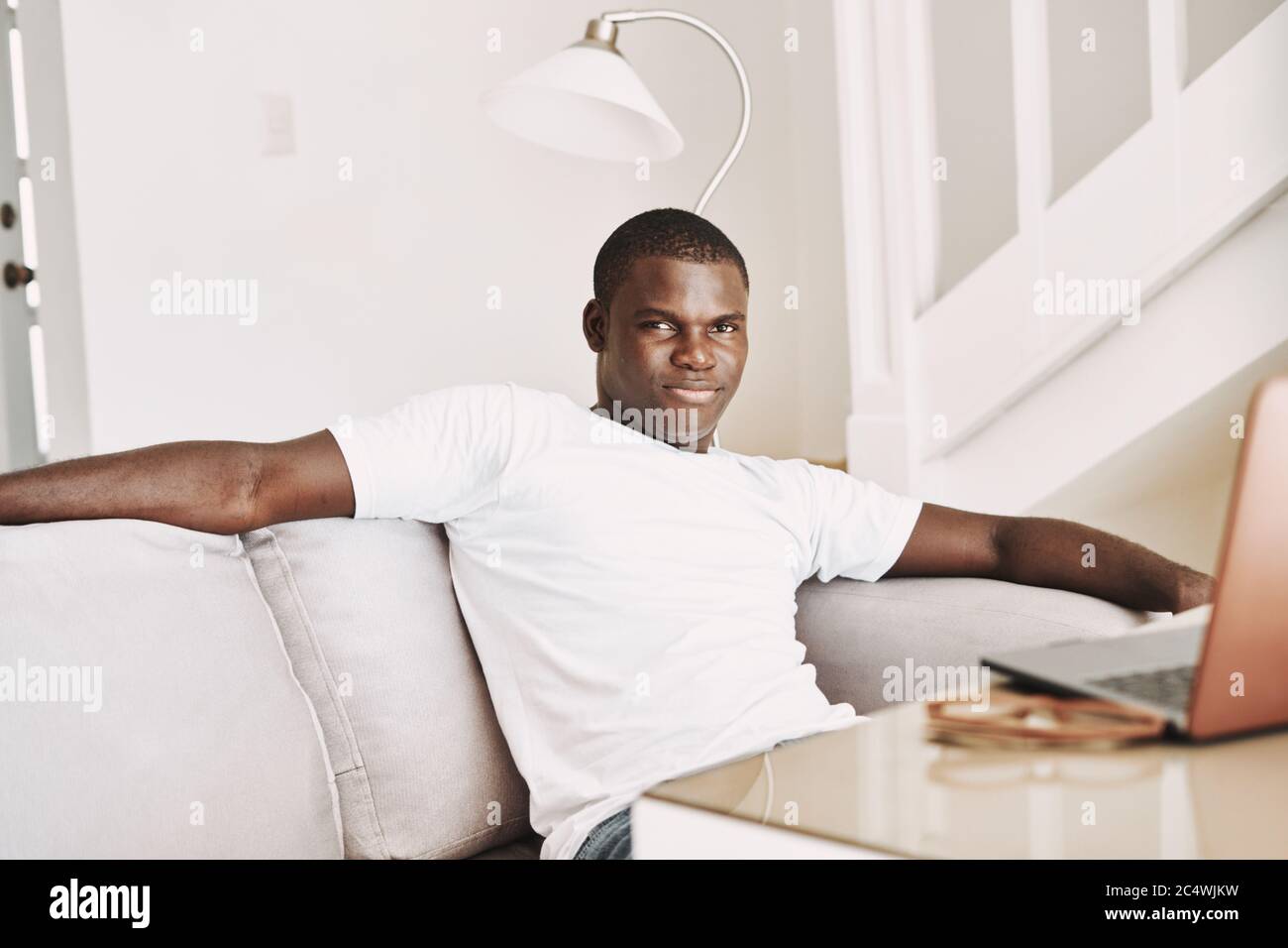 A man of African appearance on the couch Stock Photo - Alamy
