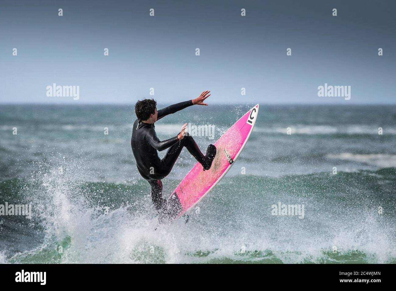 Spectacular action as a surfer gets in the air from a wave at Fistral ...