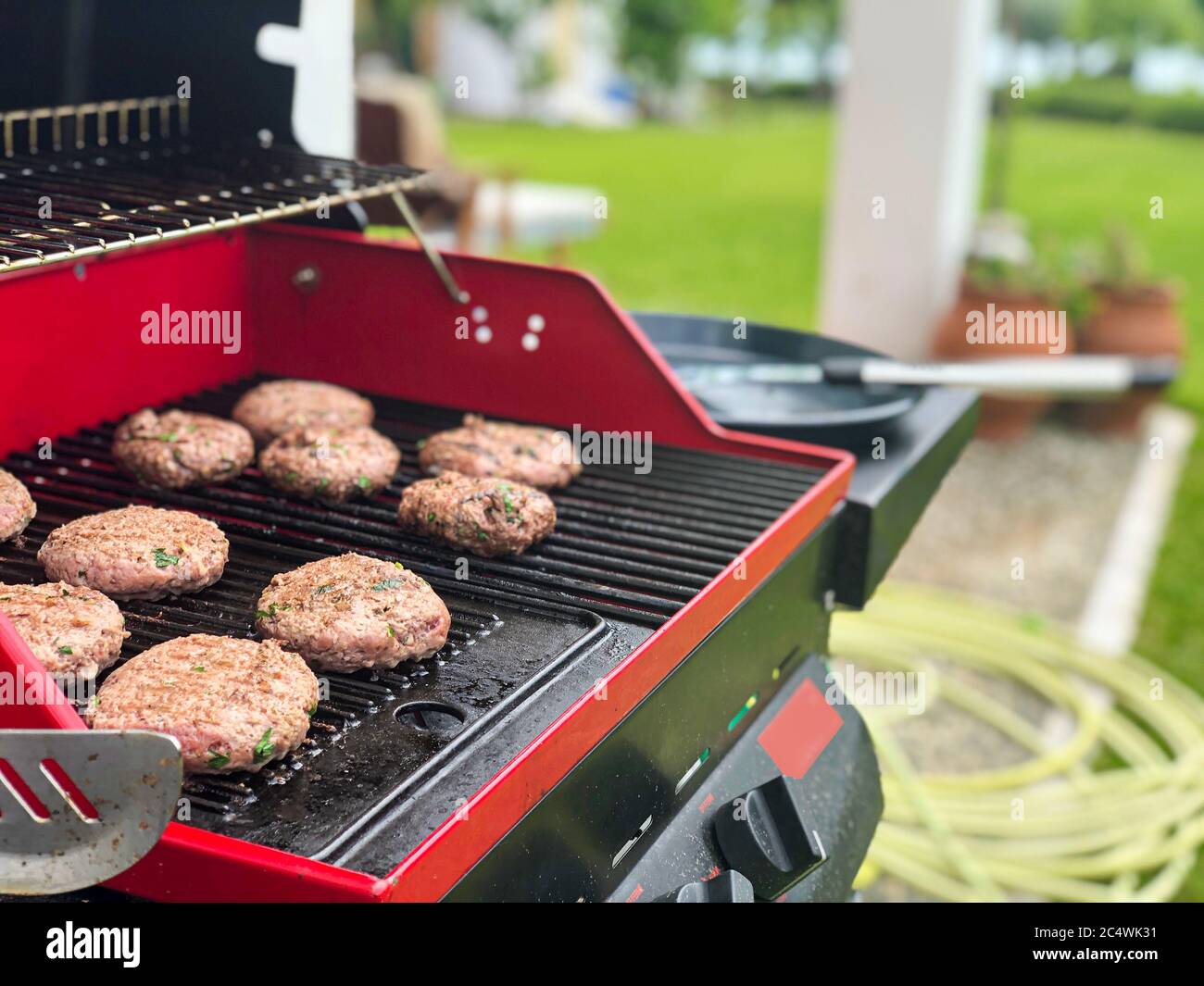 Summer barbeque cooking with beef burgers Stock Photo - Alamy