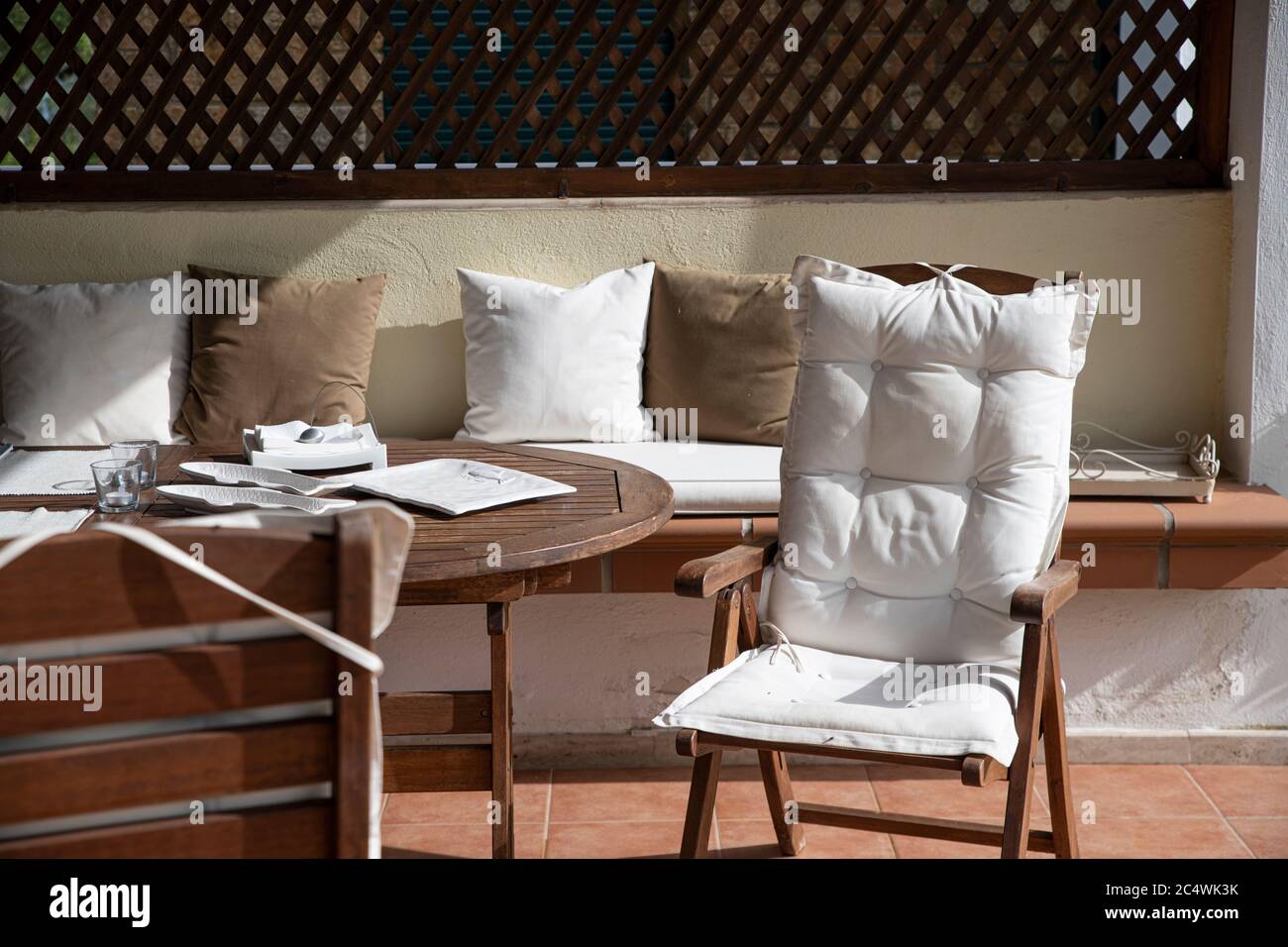 Classic wooden table with comfortable chairs around Stock Photo - Alamy
