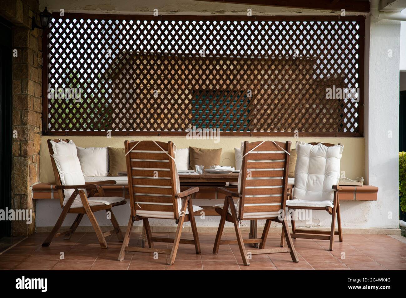Classic wooden table with comfortable chairs around Stock Photo - Alamy