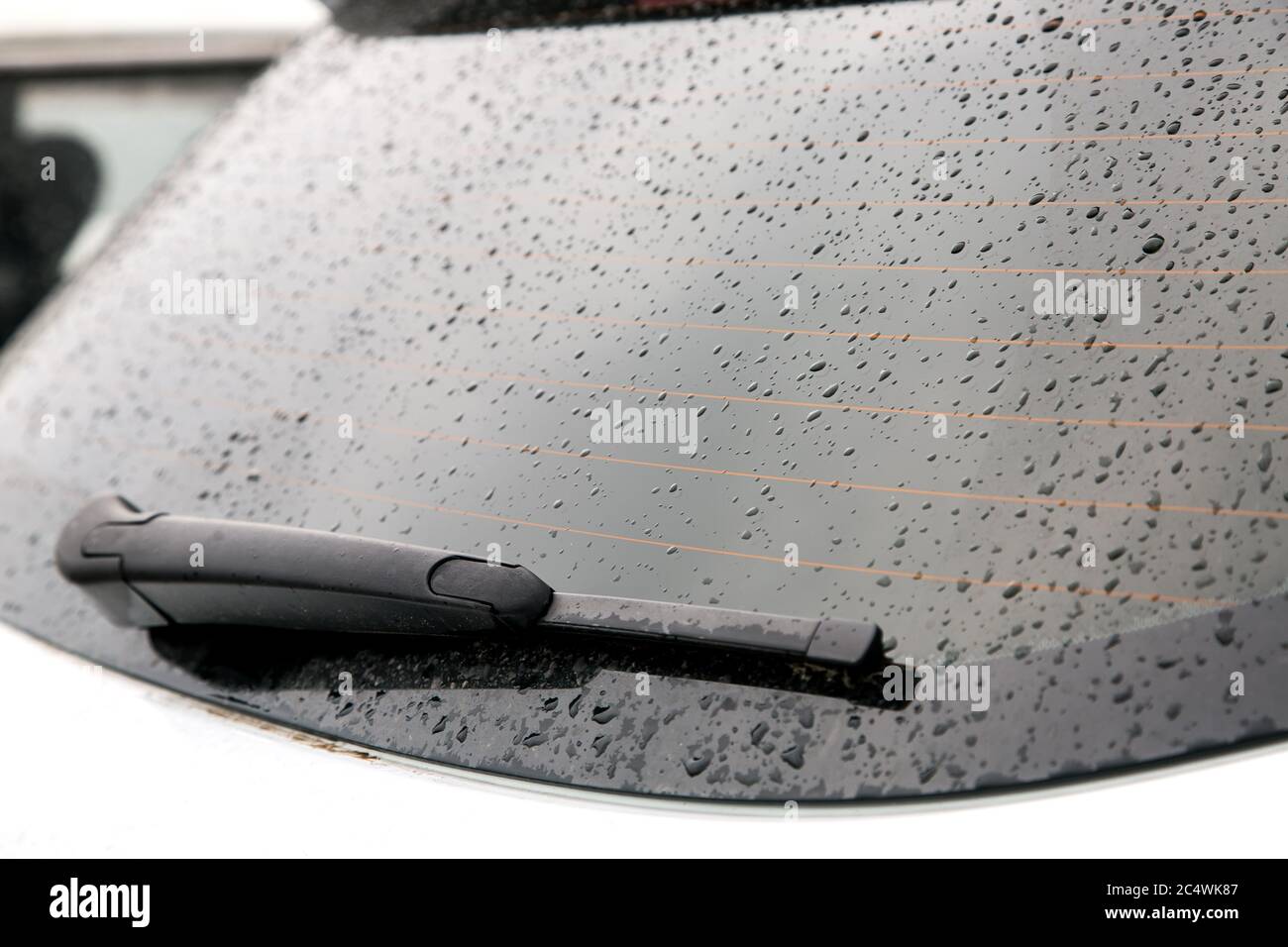 The rear window of the car is covered with water droplets after the ...