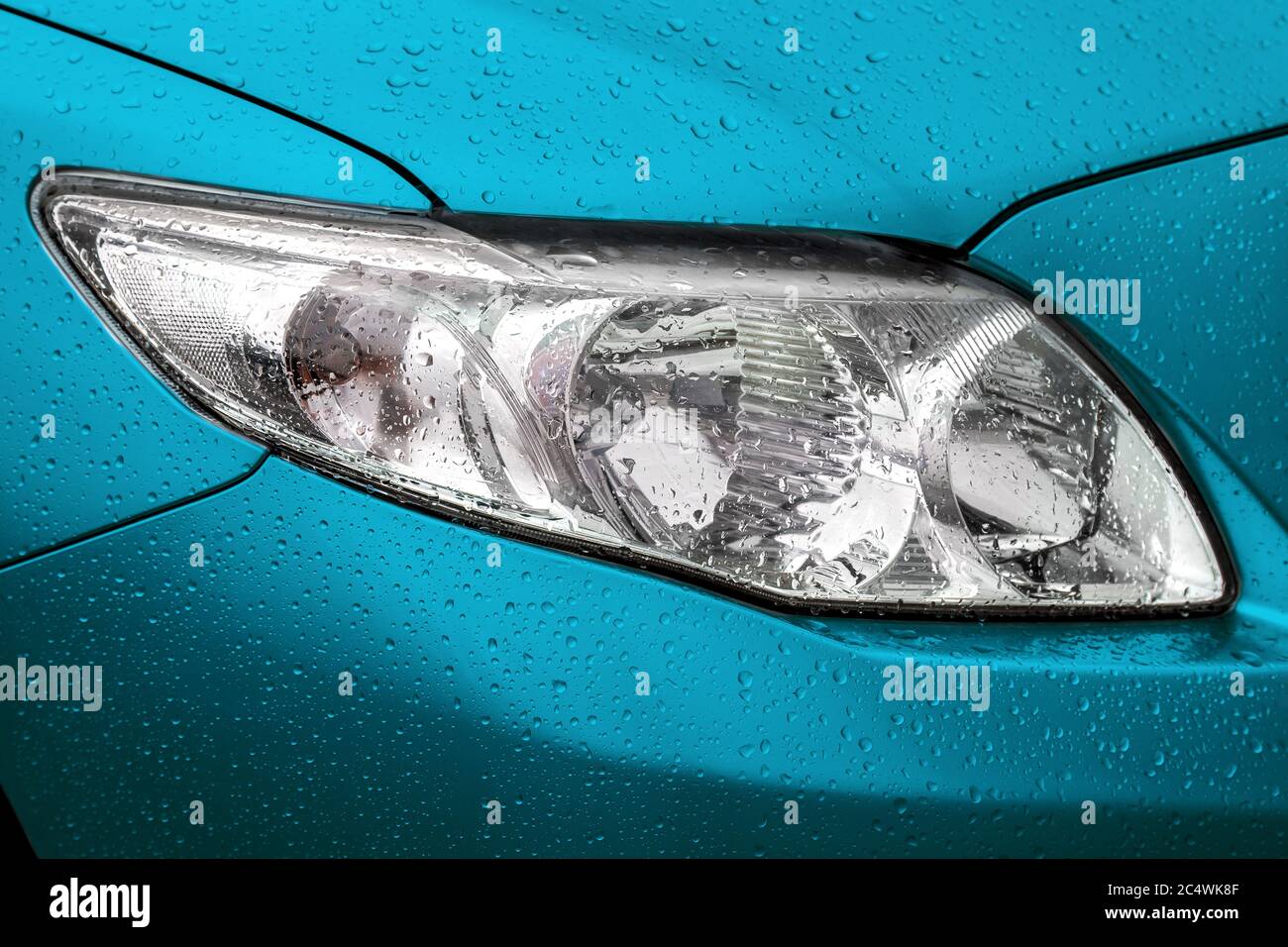 wet in a droplet car headlight blue color close-up Stock Photo - Alamy