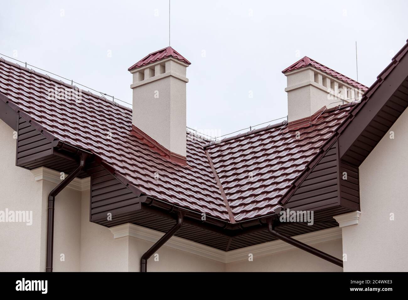 a roof top of a brown ceramic tile with ventilation by a pipe a storm ...