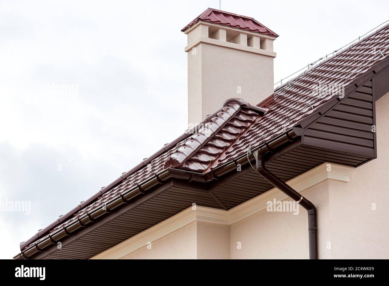 a brown rooftop of a ceramic tile with a pipe a storm drainage system ...