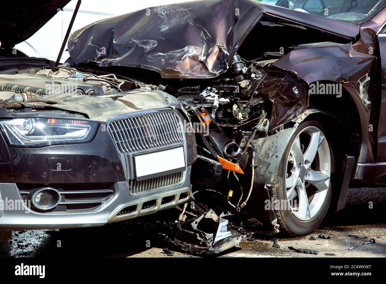 Head-on collision of two cars, close-up of damaged cars at the time of ...