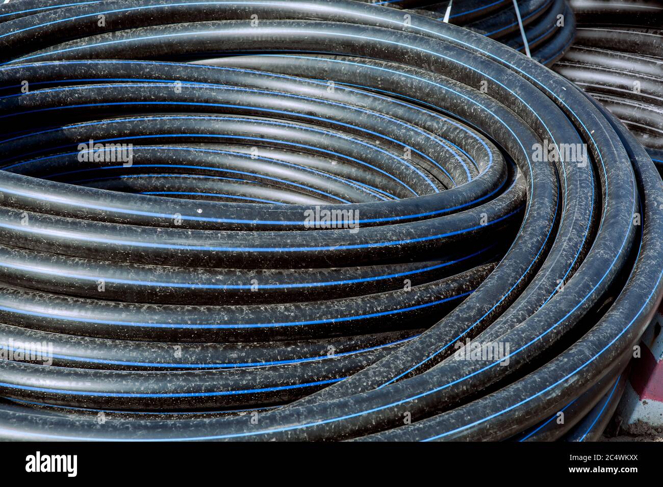water HDPE black pipes placed outdoors in spool, nobody Stock Photo - Alamy