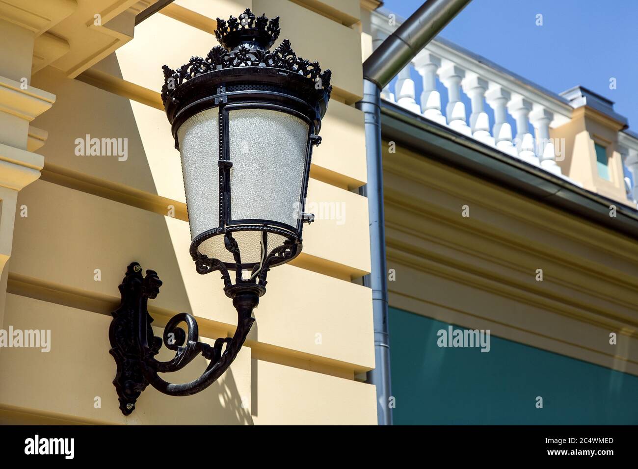 Lantern mounted on the wall of the facade of the building, iron ...