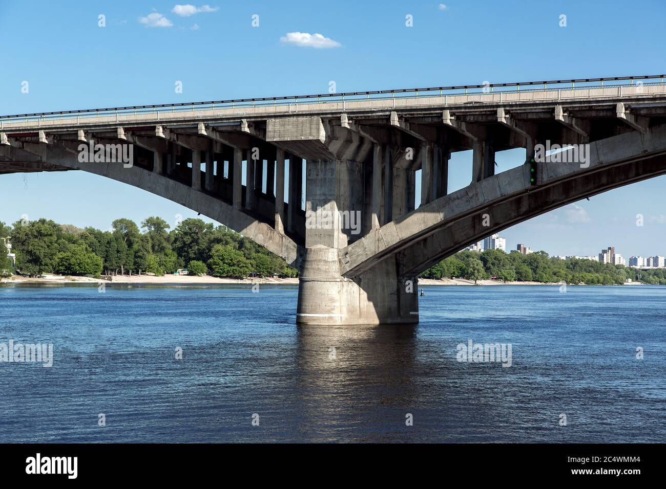Concrete bridge pillar arch structure in river water, close-up of the ...
