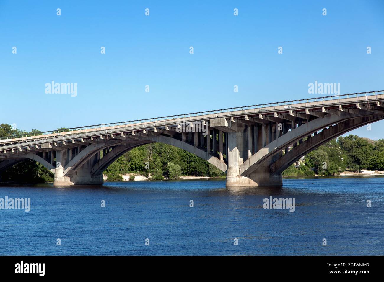 The bridge across the pond is an arched monolithic concrete structure ...