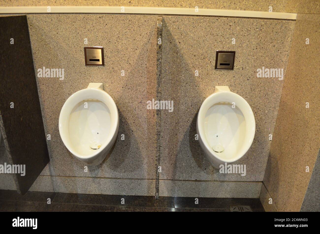 Men's room with white porcelain urinals Stock Photo - Alamy