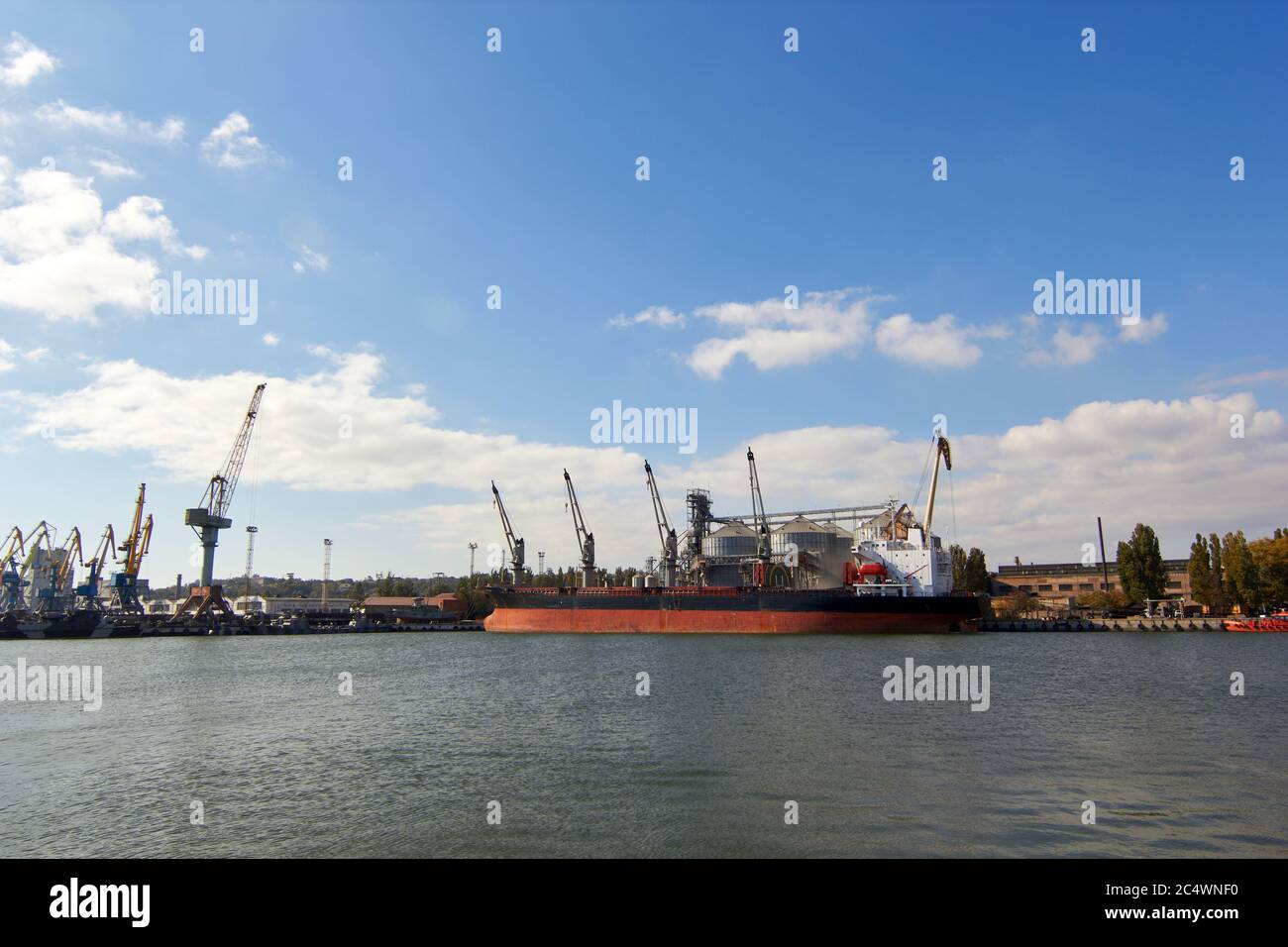 Big grain terminal at seaport. Cereals bulk transshipment from road ...