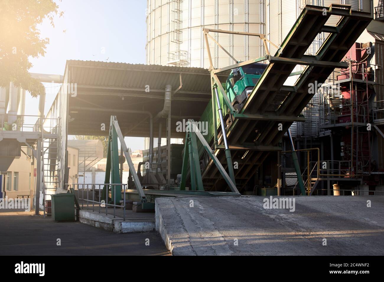 Unloading grain truck at elevator on elevating hydraulic platform ...