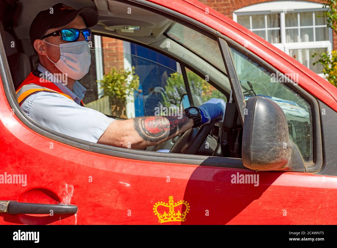 Royal Mail postman wearing face mask during the Coronavirus Pandemic ...