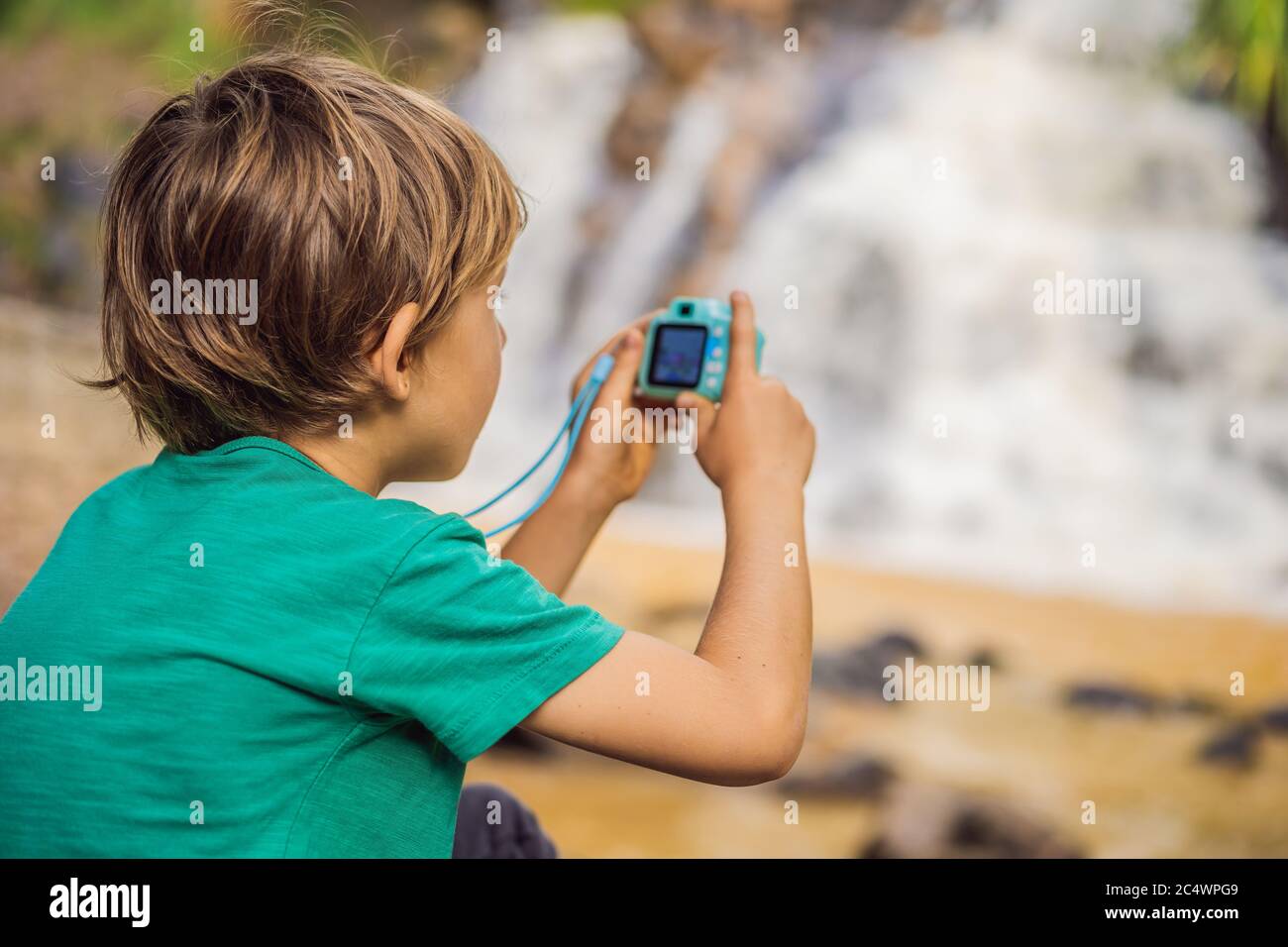 Little photographer taking picture with toy camera Stock Photo - Alamy