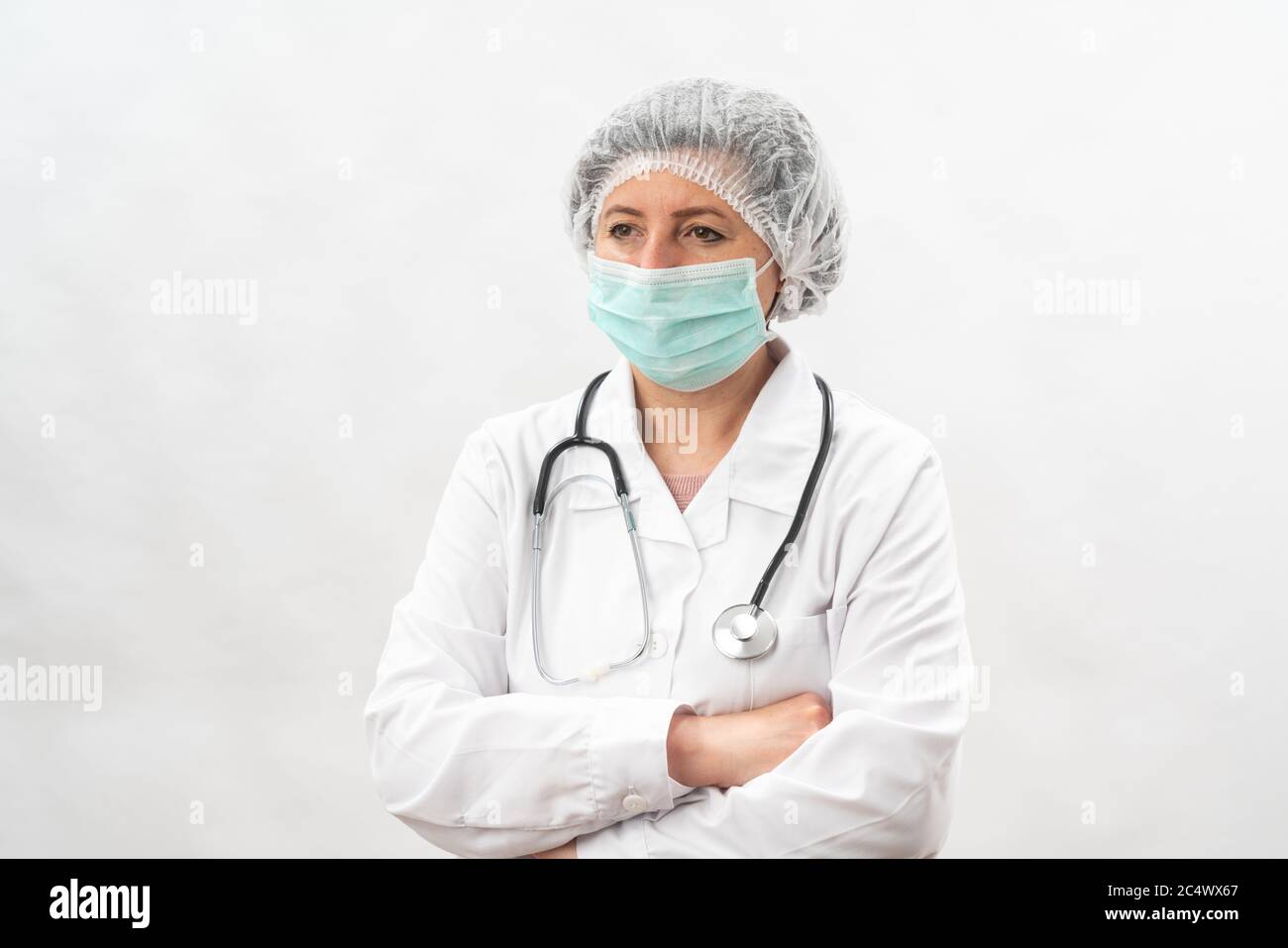 Tired female medic, nurse in protective equipment and a mask from ...