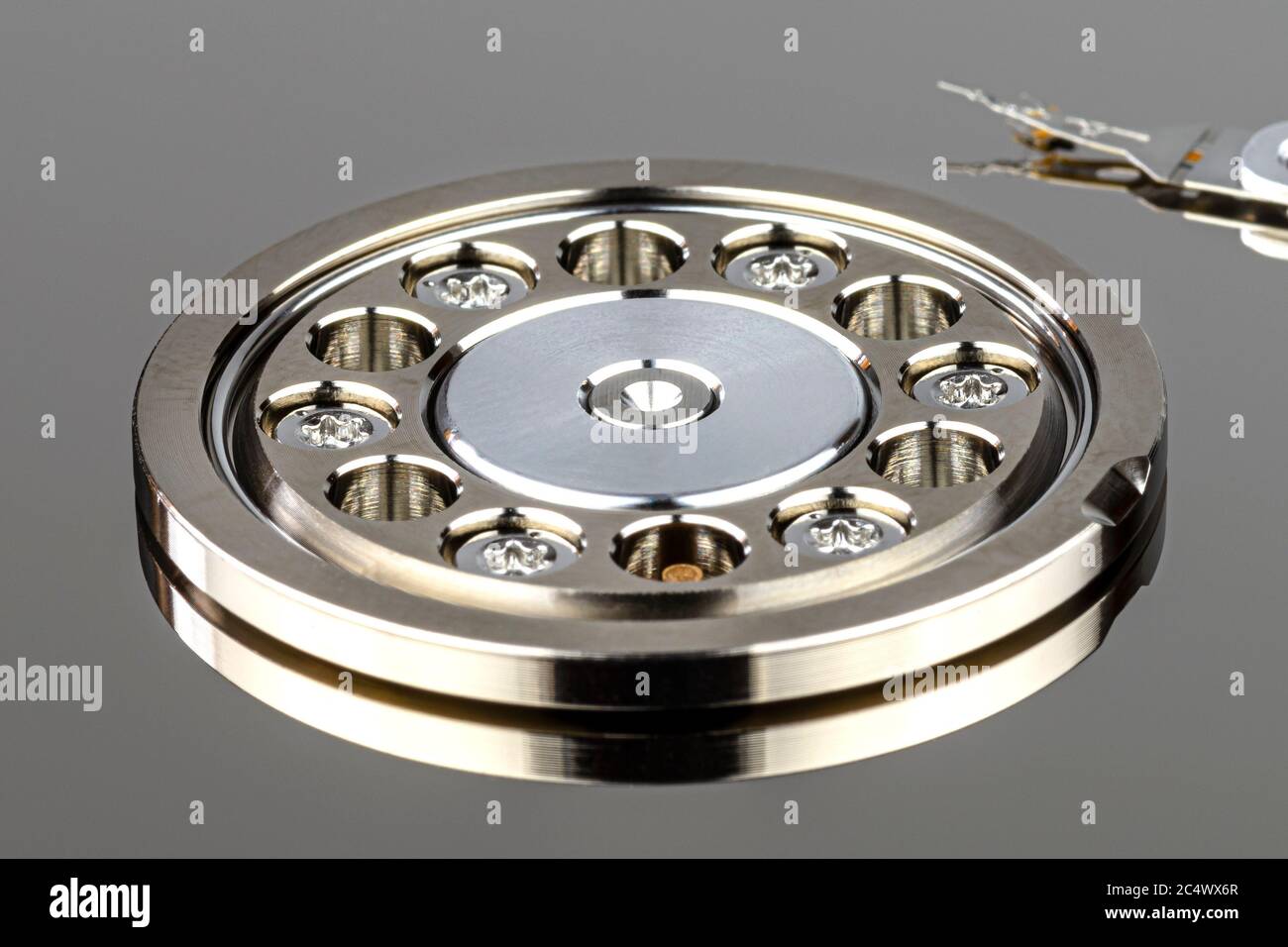 Macro shot of a magnetic needle on a hard disk platter, open HDD disk ...