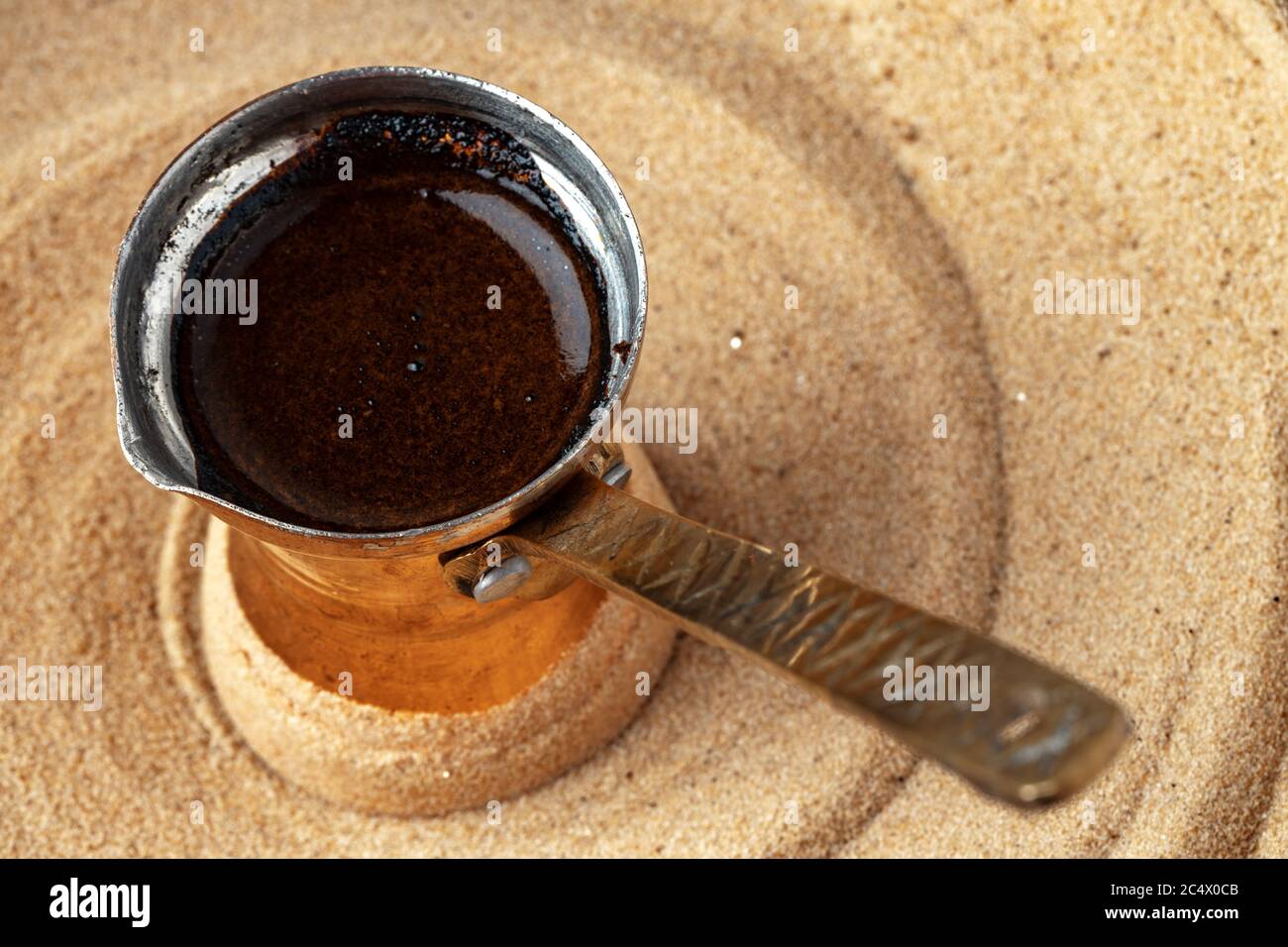 Process of preparation of coffee in turk in cezve on sand Stock Photo ...