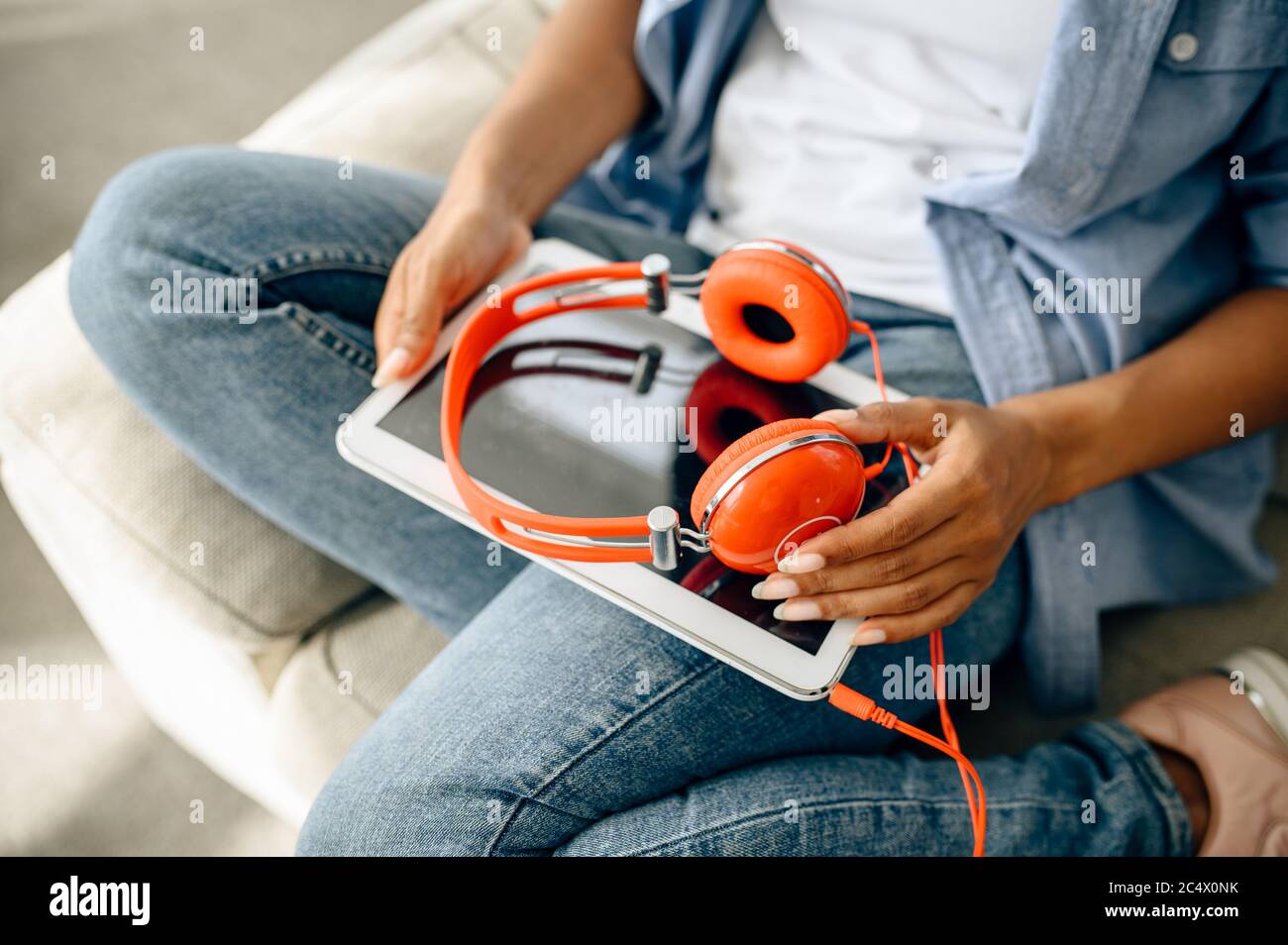 Female person with headphones and tablet pc Stock Photo - Alamy
