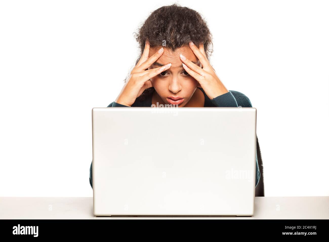 Frustrated young african woman at her laptop on white background Stock ...