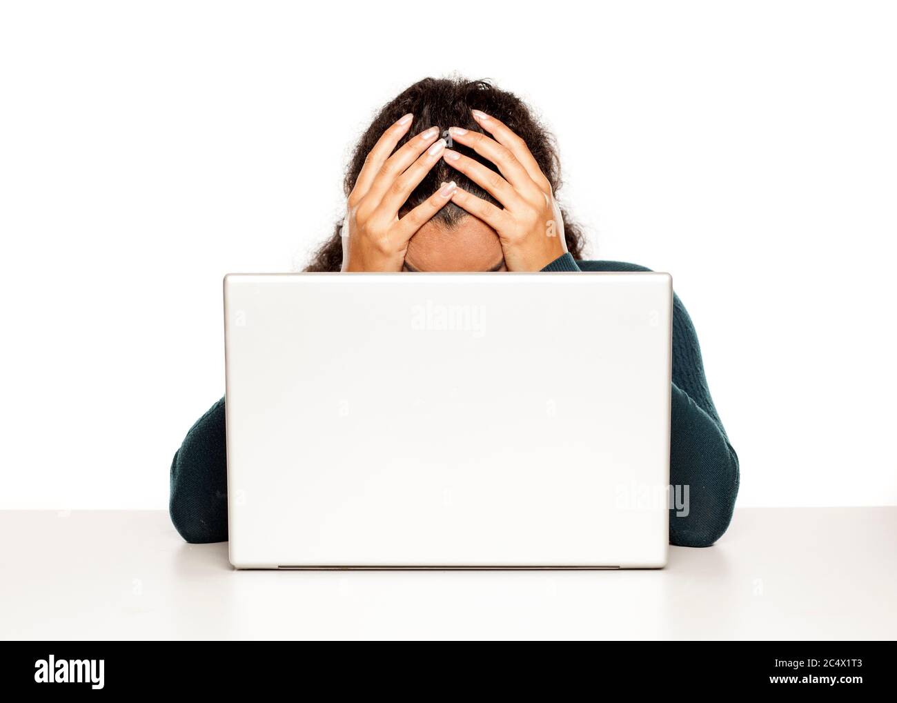 Frustrated young african woman at her laptop on white background Stock ...