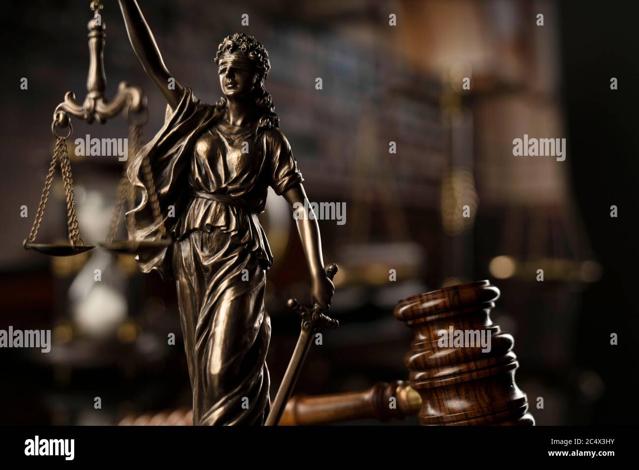 Law theme. Court library. Gavel, scale and Themis statue on brown ...