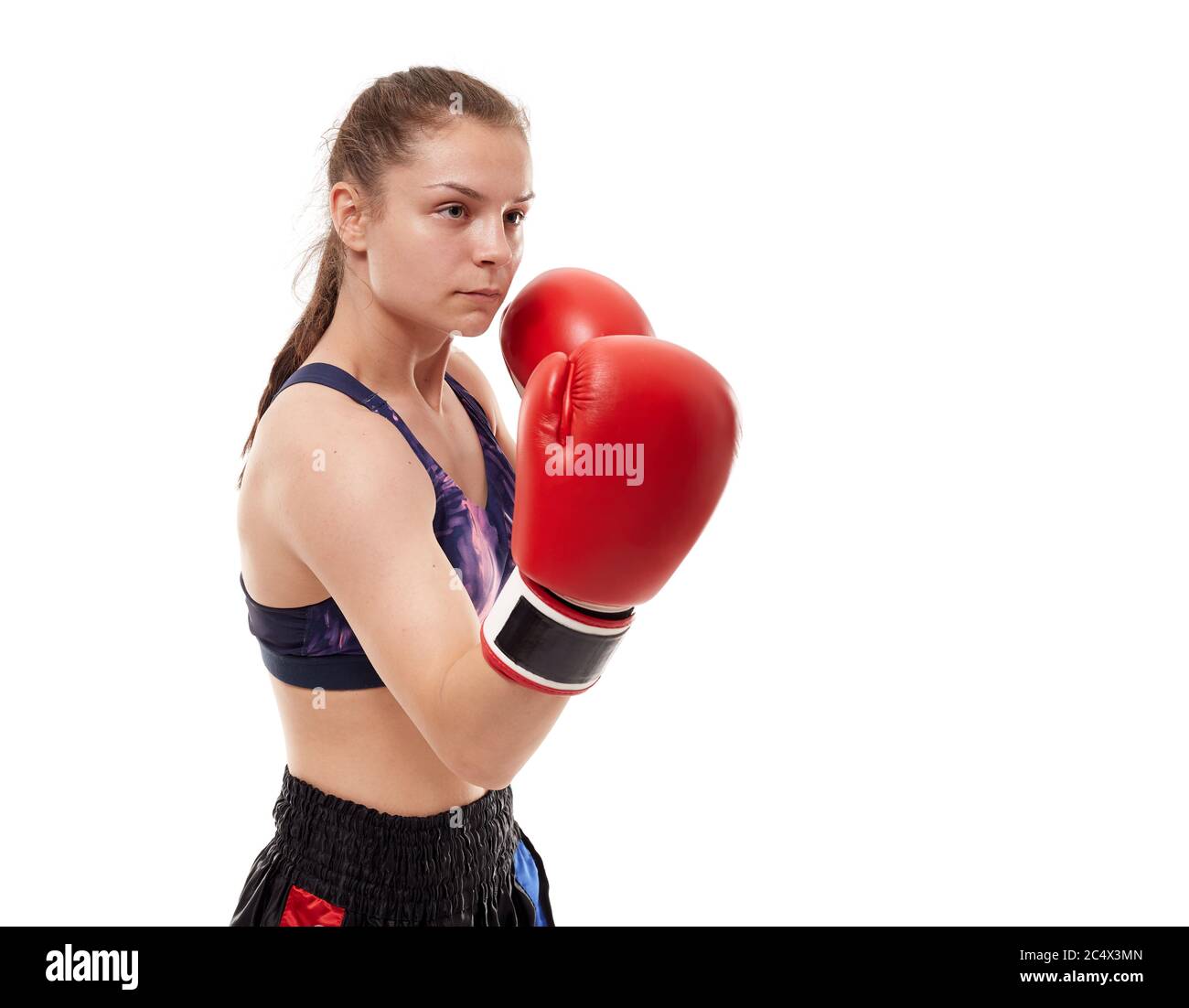Young girl kickboxing fighter training, isolated on white background ...