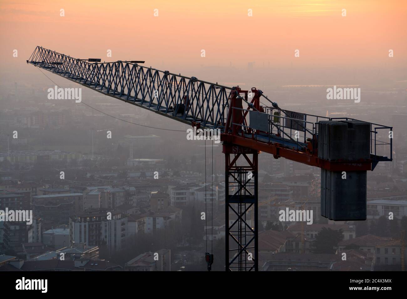 Large and tall construction crane overlooking a city Stock Photo - Alamy