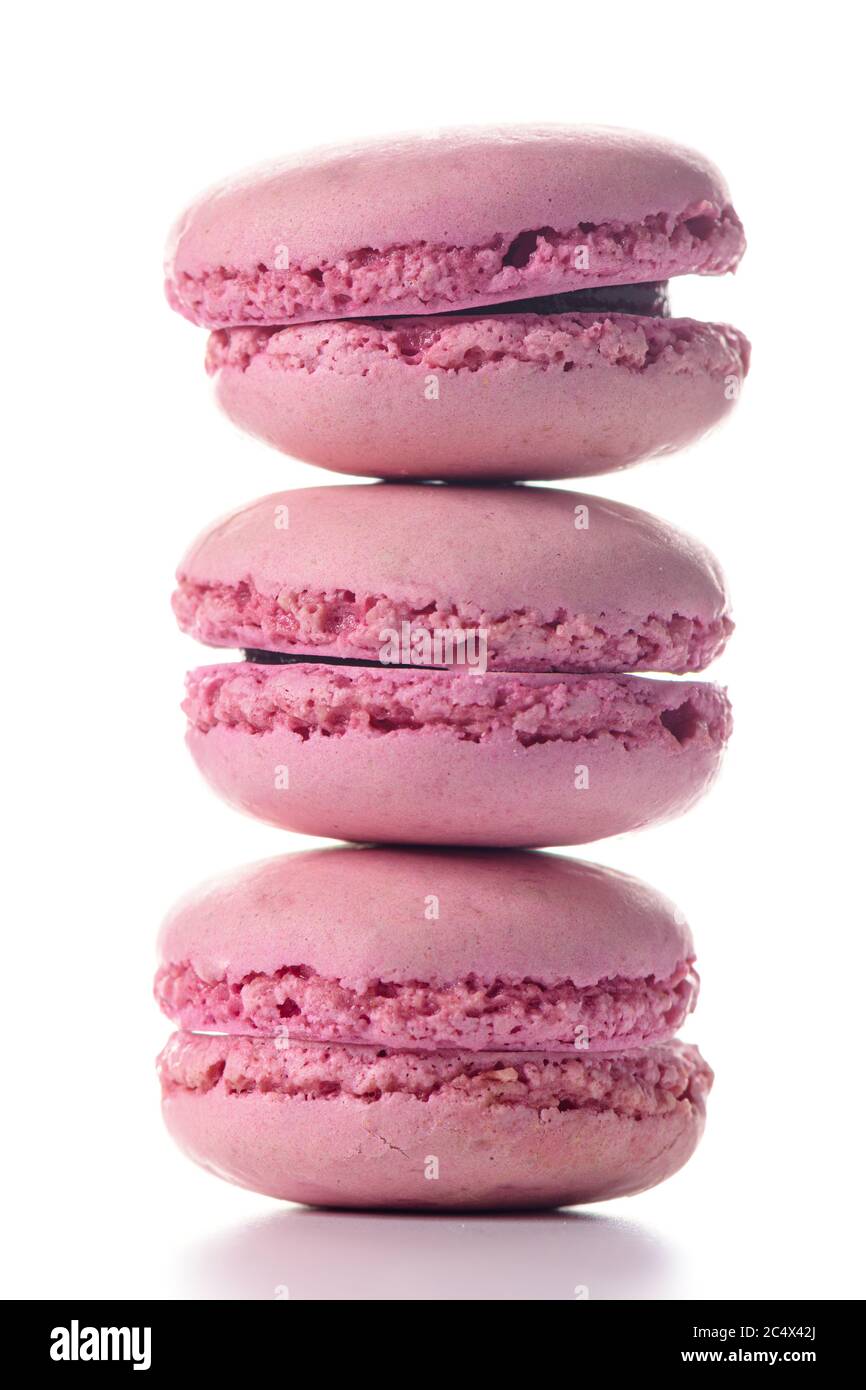 Three raspberry flavoured macaroons standing on top of each other on ...