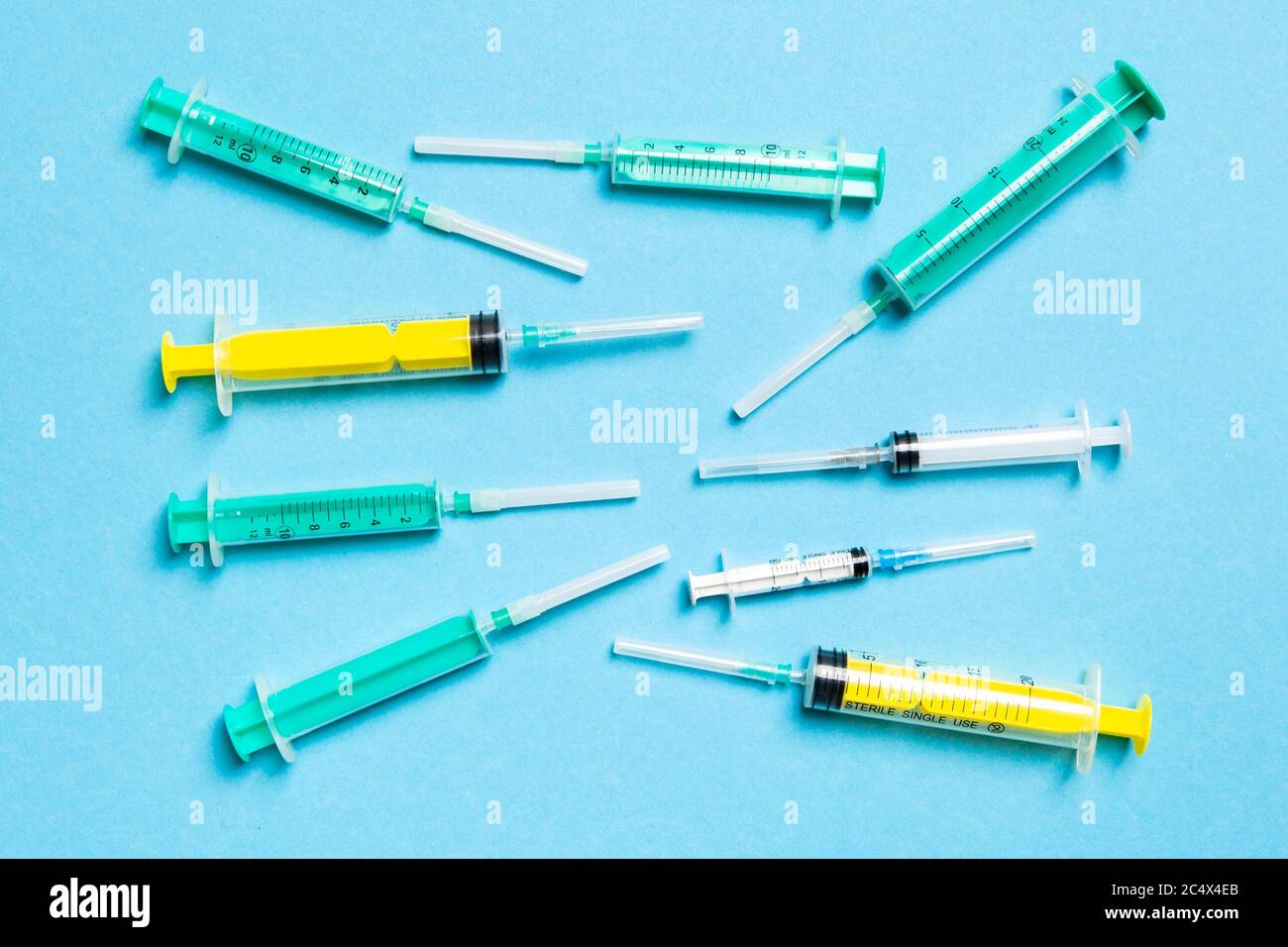 Top view of different syringes at blue background. Medical injection ...