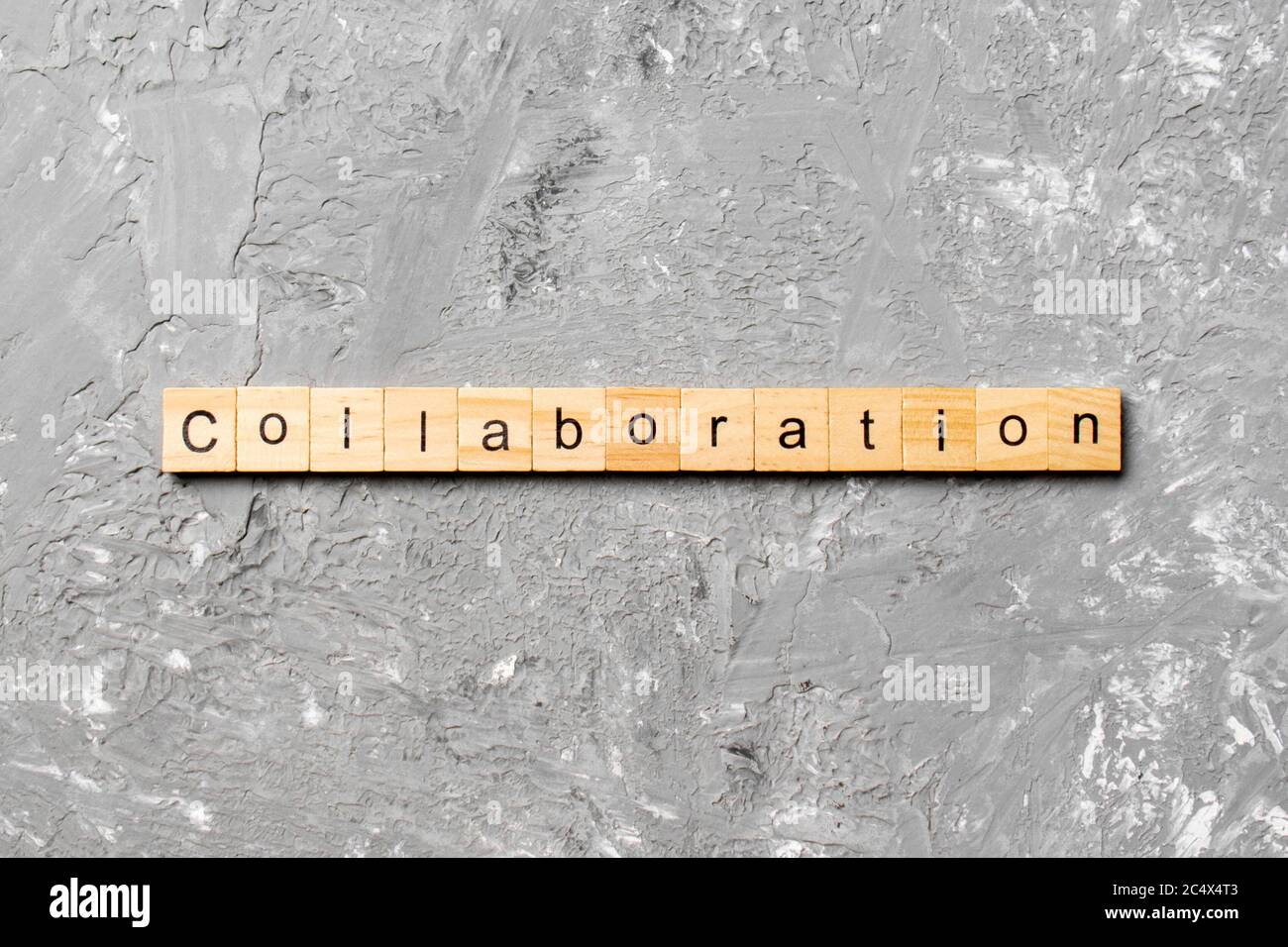 Collaboration word written on wood block. Collaboration text on cement ...