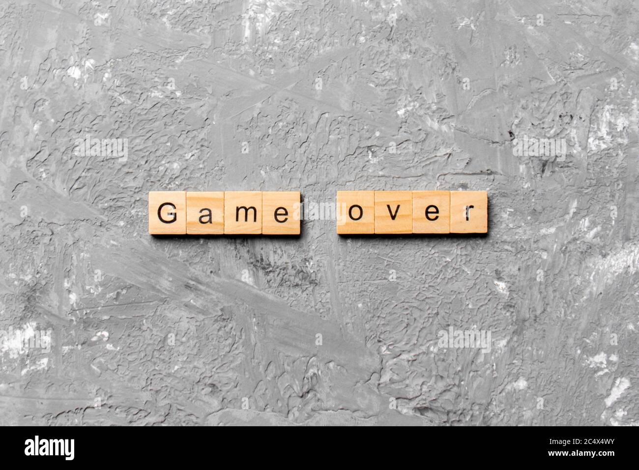 game over word written on wood block. game over text on table, concept ...