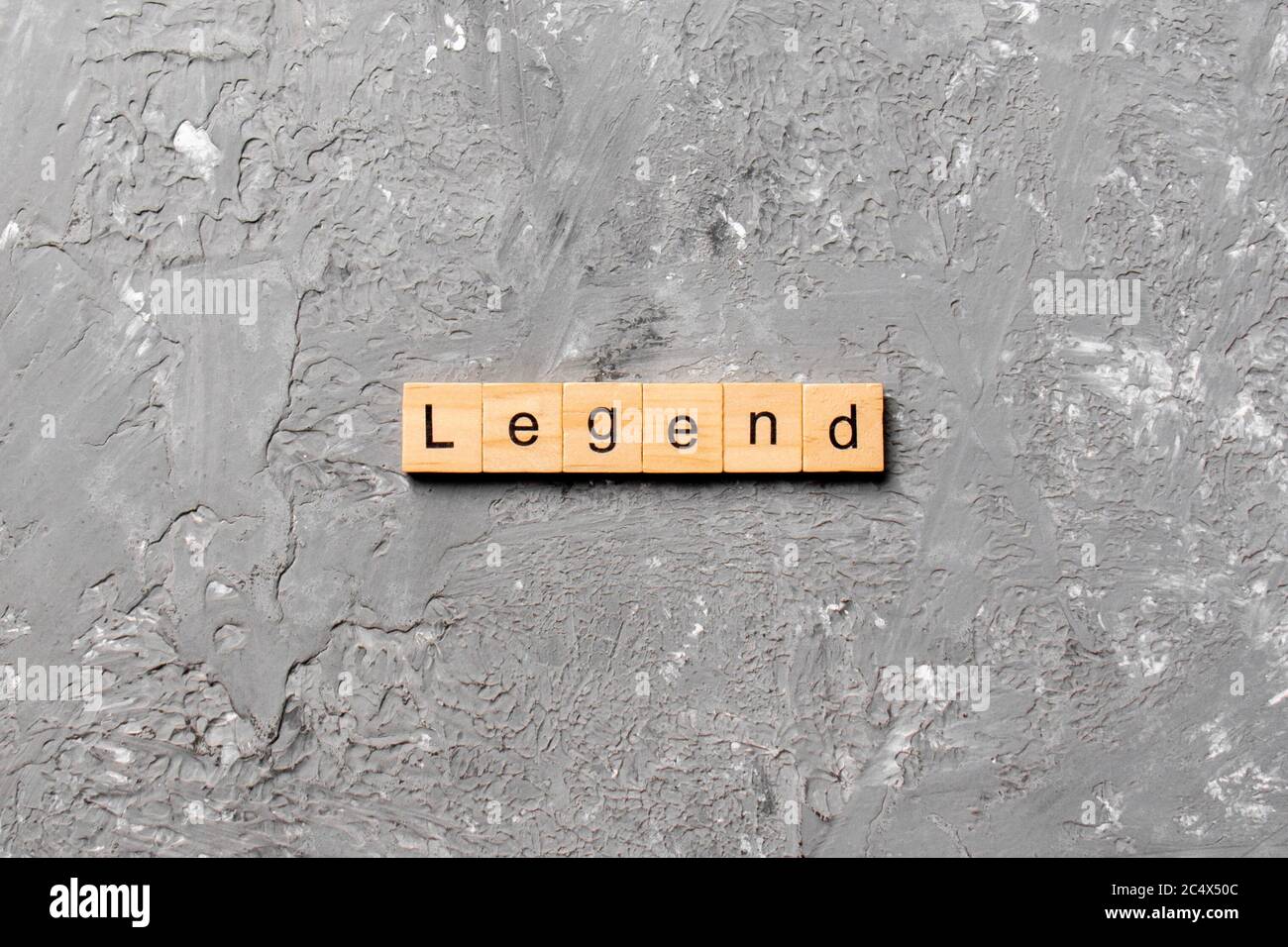 legend word written on wood block. legend text on cement table for your ...