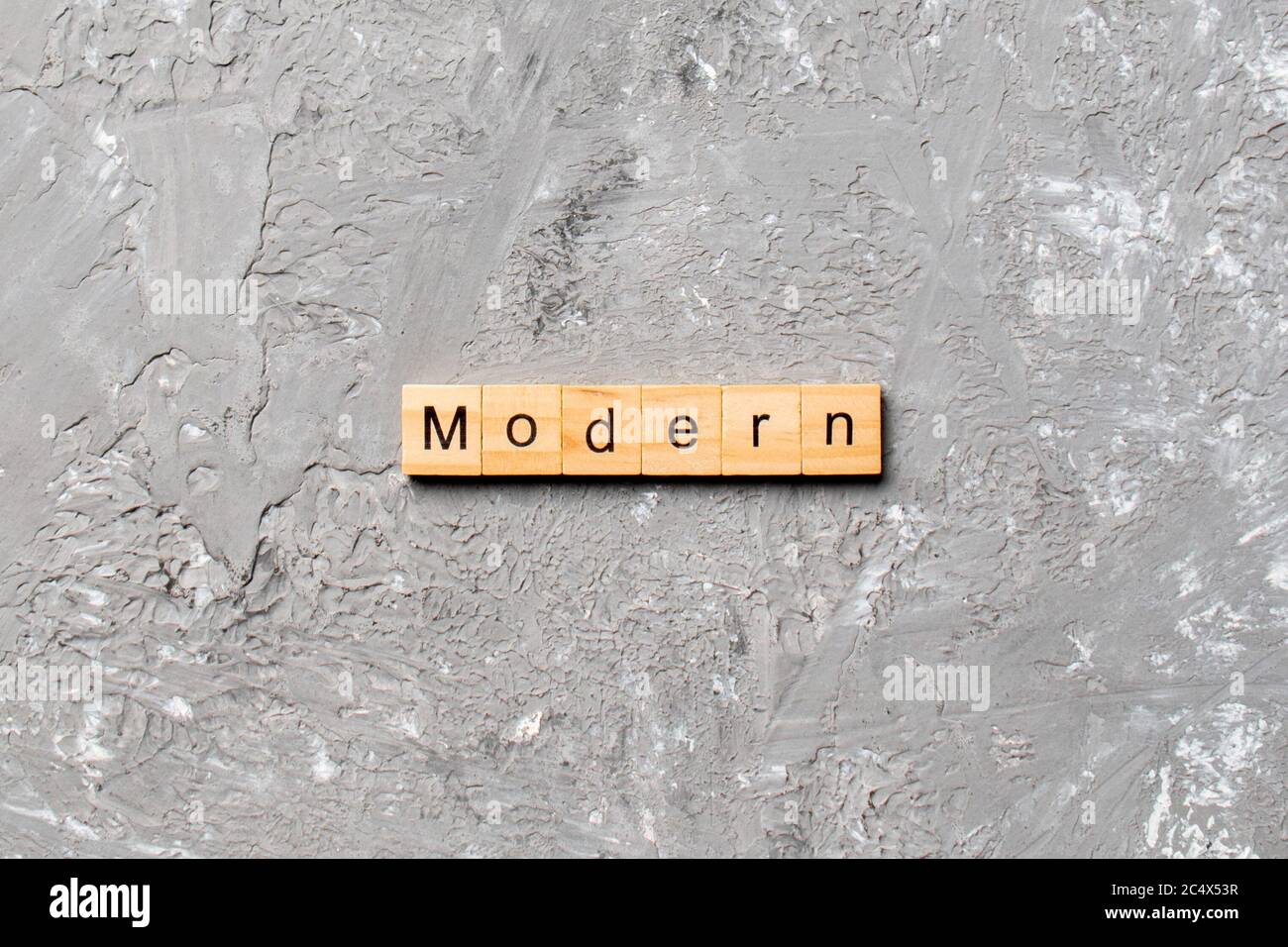 modern word written on wood block. modern text on cement table for your desing, concept Stock ...